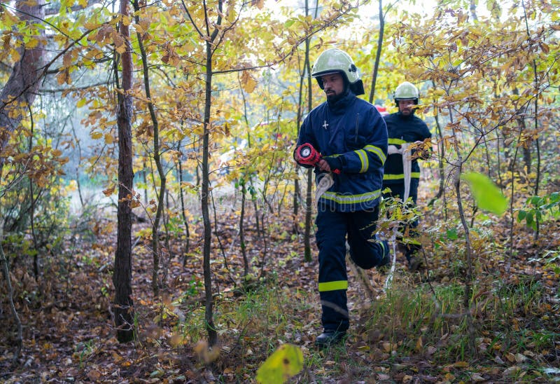 Firefighters Men at Action, Running through Smoke with Shovels To Stop ...