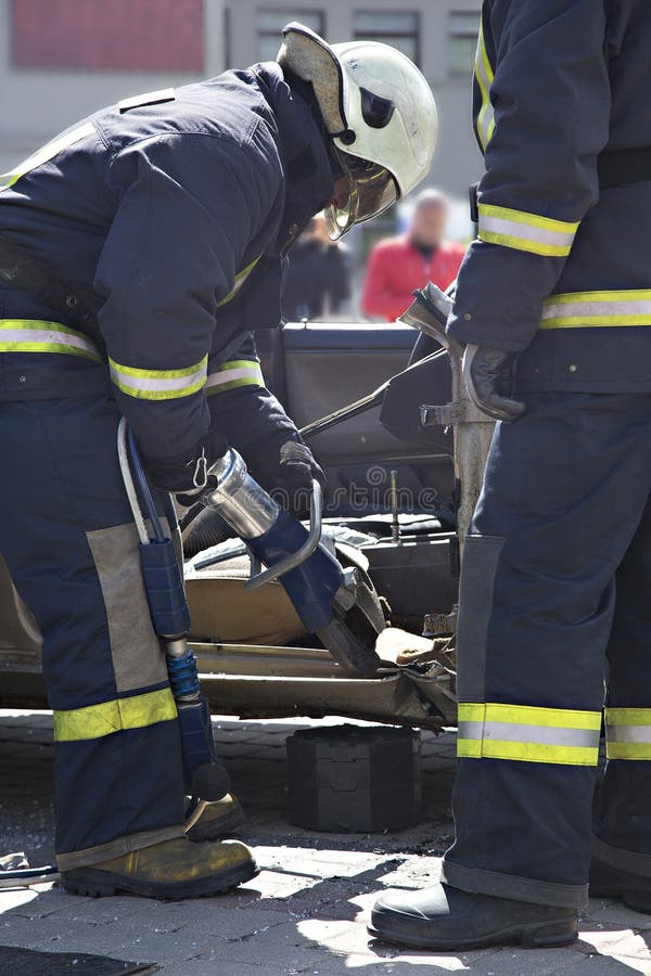 Firefighters with Shears Open the Car Doors after a Serious Car Stock ...