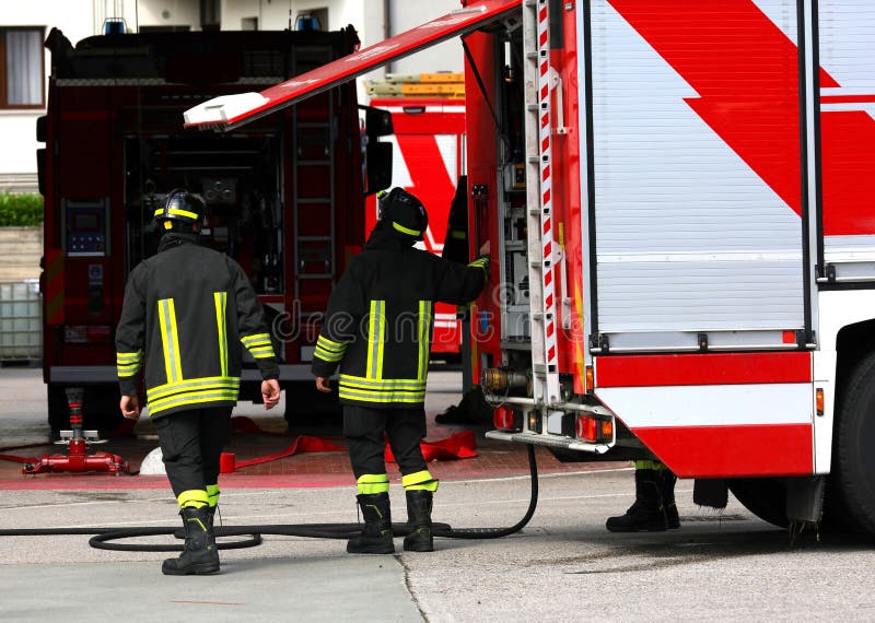 Firefighters with Protective Helmets during an Emergency Intervention ...
