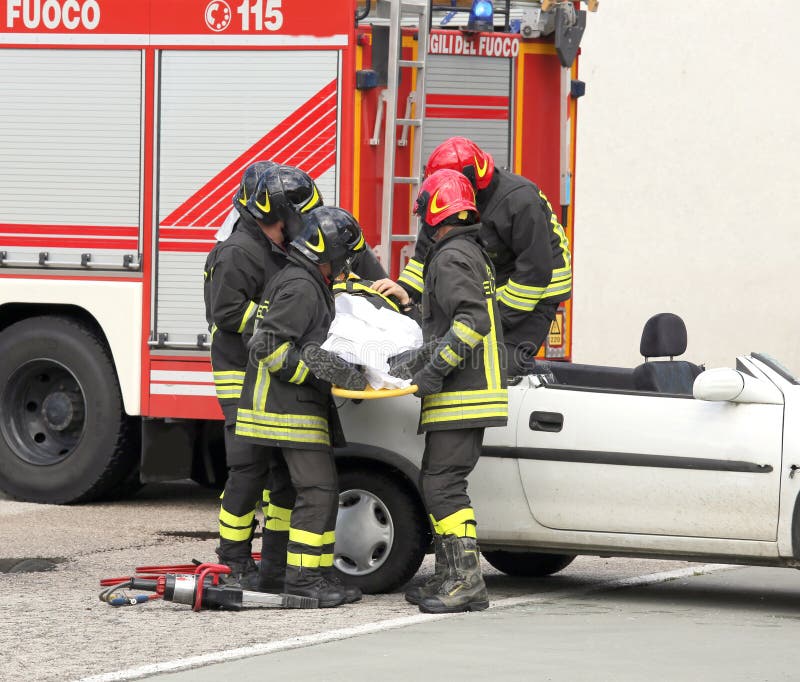 Firefighters Relieve an Injured after Car Accident Stock Photo - Image ...
