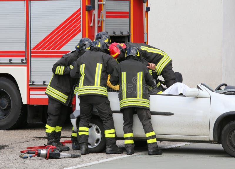 Firefighters Relieve an Injured after Car Accident Stock Image - Image ...