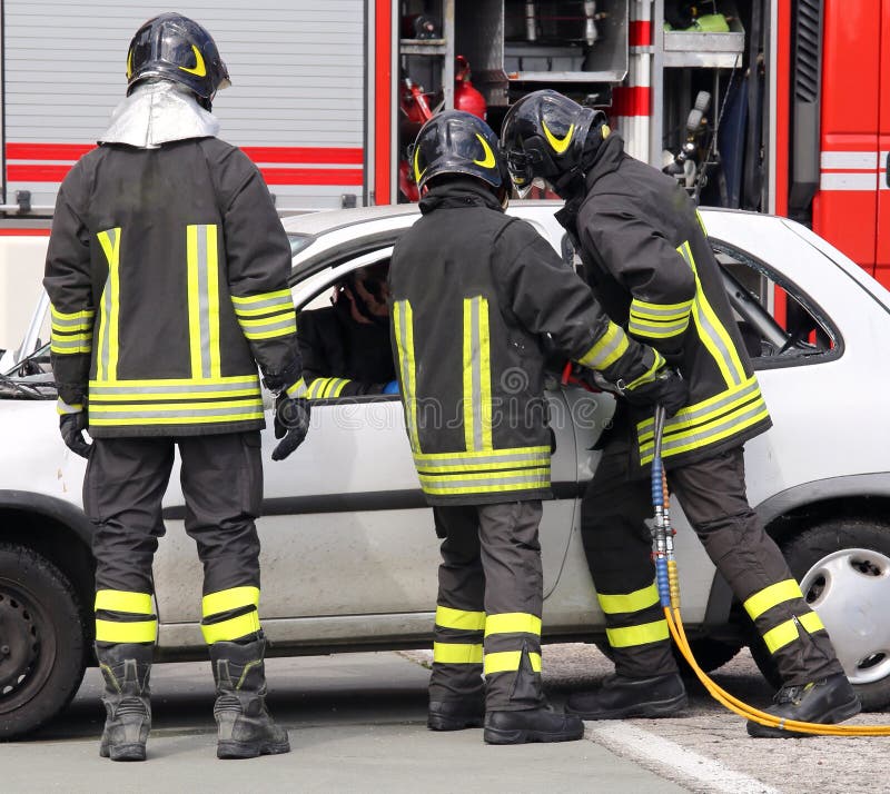 Firefighters Relieve an Injured after a Road Accident Stock Image ...