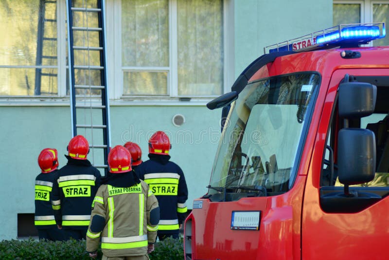 Many Firemen during Rescue Operations with a Big Ladder Stock Photo ...