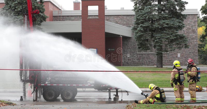 Fireman Spray the Water To the Building To Prevent Fire Happen Stock ...