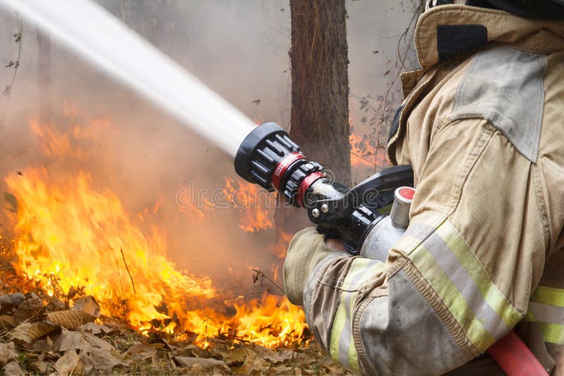 Firefighters Spray Water To Bushfire Stock Photo - Image of attack ...