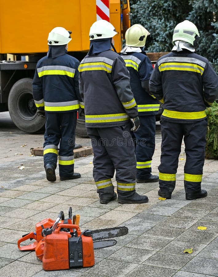 Firefighters Next To a Fire Truck Extinguishing a Fire Stock ...