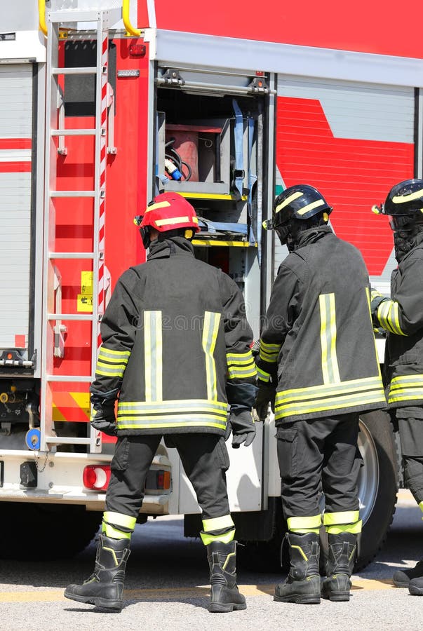 Firefighters Taking Equipment from Fire Truck during Emergency Stock ...
