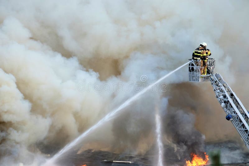Firefighters Trying To Stop the Fire Surrounded by Heavy Smoke Stock ...