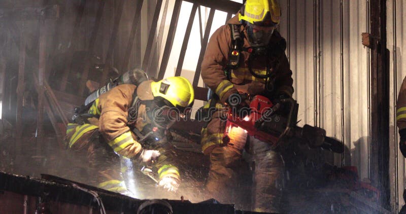Firefighters Using Axe and Halligan on Involved Roof on Fire Stock ...