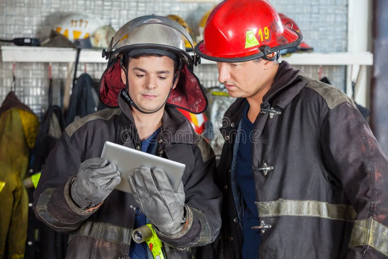 Firefighters Using Digital Tablet at Fire Station Stock Image - Image ...