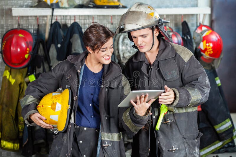 Firefighters Using Digital Tablet at Fire Station Stock Photo - Image ...