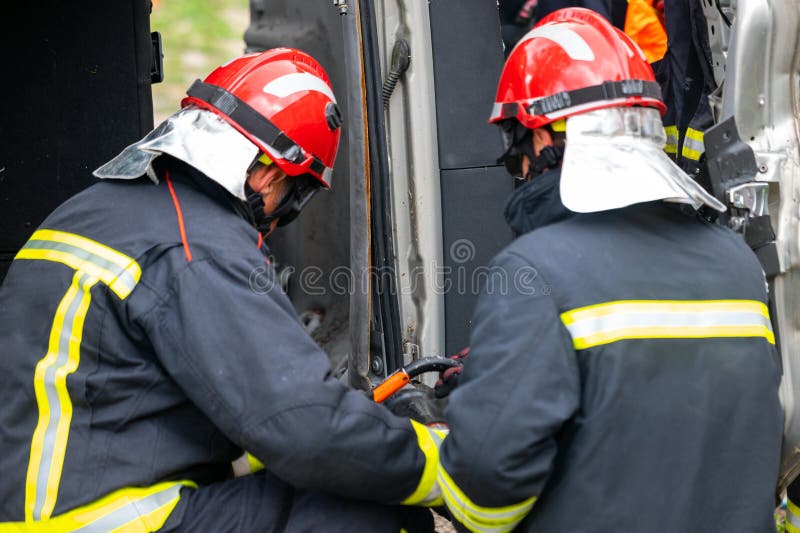 Firefighters Using Hydraulic Tools during a Rescue Operation Training ...