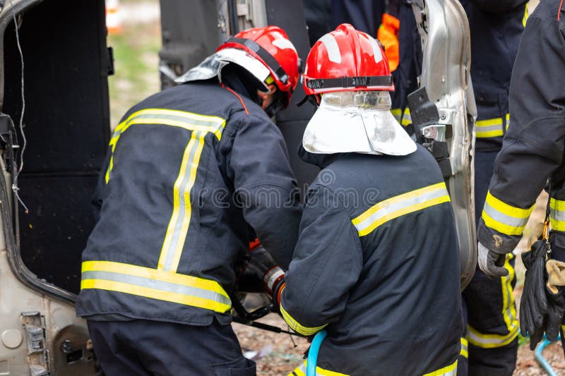 Firefighters Using Hydraulic Tools during a Rescue Operation Training ...