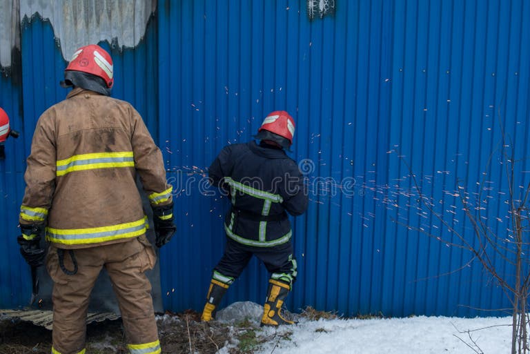 Firefighters Work on an Fire of Building Using a Metal Cutter Rescue ...