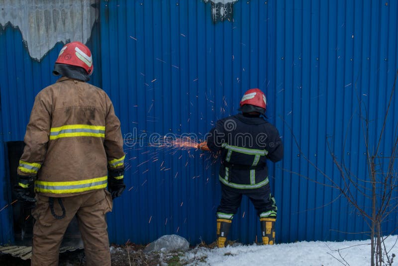 Firefighters Work on an Fire of Building Using a Metal Cutter Rescue ...