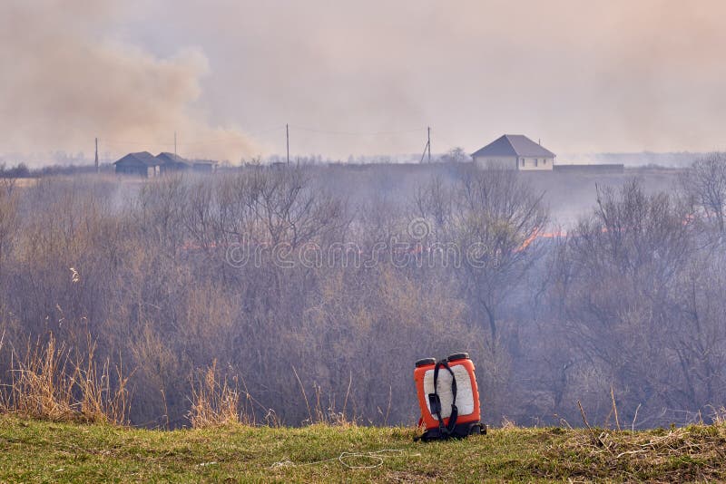 Firefighting Backpack on the Background of Grassroots Wildland Fire ...