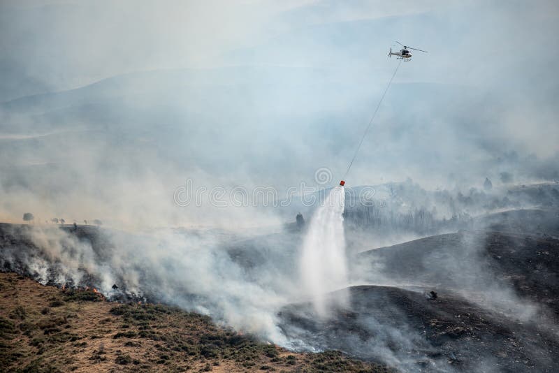 Firefighting Helicopter Drop Water on Forest Fire Stock Image - Image ...