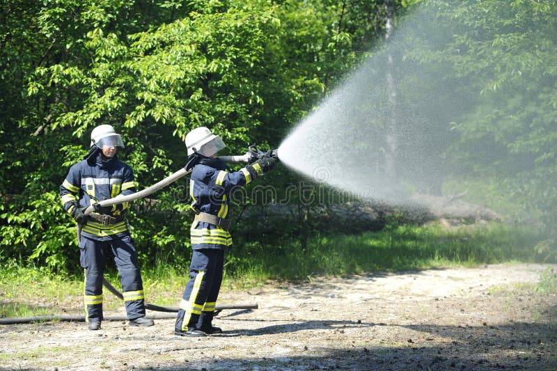 Firefighting Team Training: Firemen in Protective Ensembles Watering ...