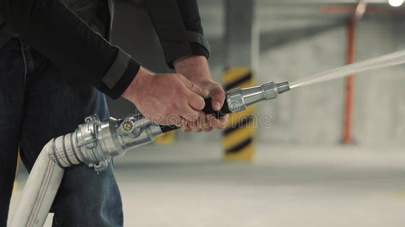 The Fireman Closes the Fire Hydrant. Fire Fighting Opening the Faucet ...