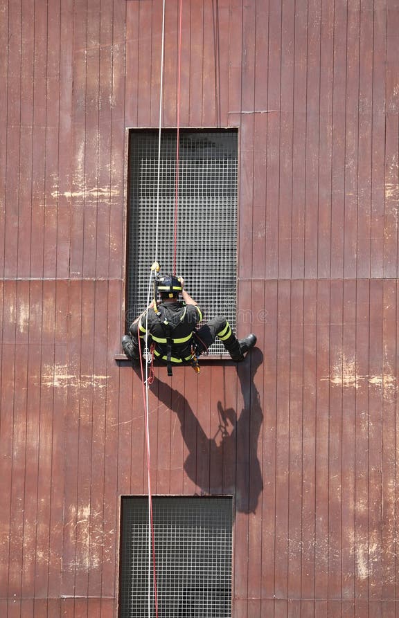 Fireman Descending from the House with the Double Rope Technique Stock ...