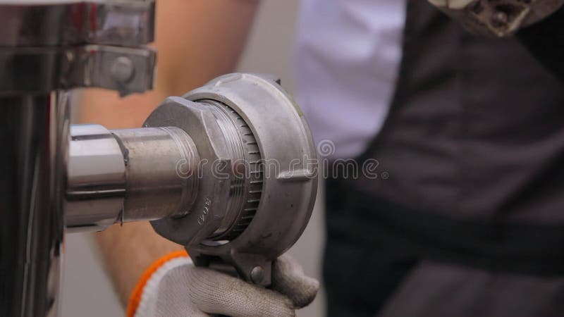 The Fireman Disconnects the Fire Hose. Disconnecting a Fire Hose Close ...