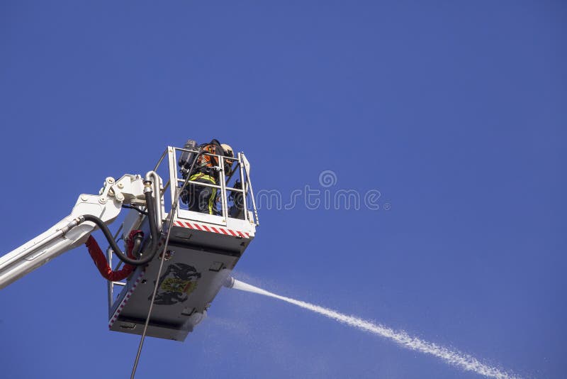 An Extended Boom of a Truck Crane Lifts a Concrete Tank To the Top ...