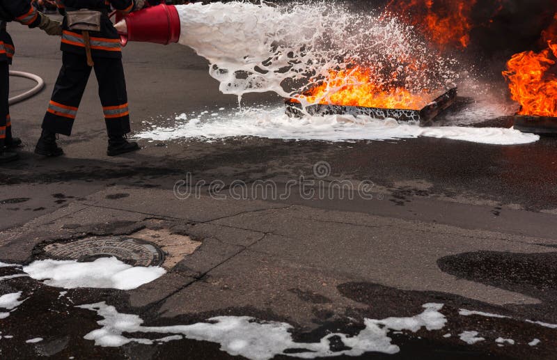Firefighter Extinguishes the Fire with Smoke Stock Photo - Image of ...