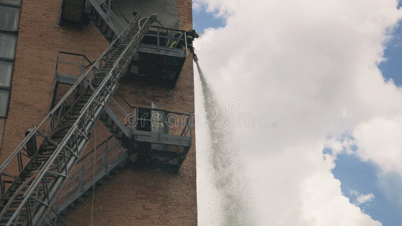 Fireman Extinguishing Fire from Height Stock Image - Image of ...