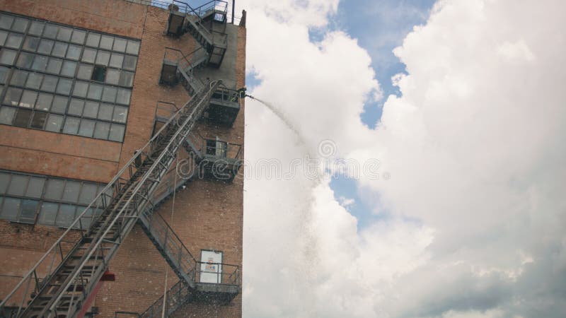 Fireman Extinguishing Fire from Height Stock Image - Image of wall ...