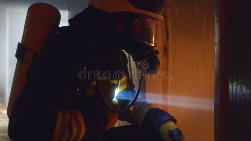 Firefighter Searching for Survivors in Burning Building Stock Image ...