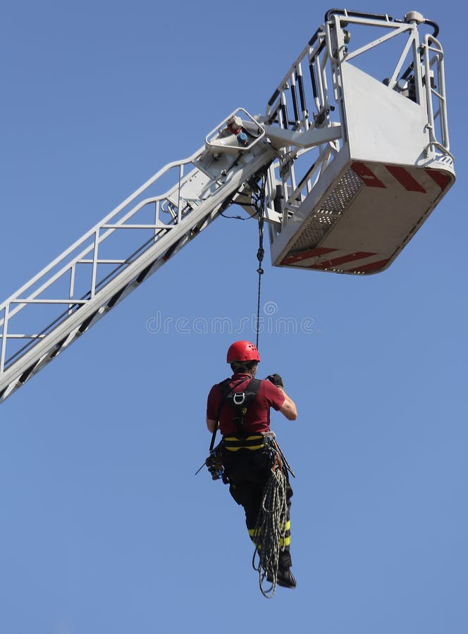 Firefighter Climbing an Aerial Ladder Stock Image - Image of fire, fair ...