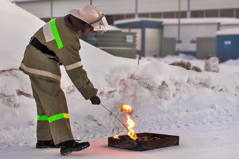Fireman Makes a Fire Outdoors. Training the Pressure of the Open Fire ...