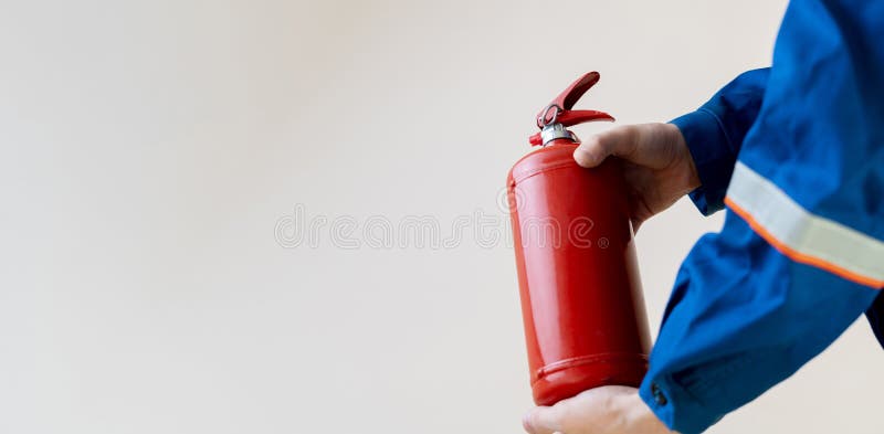 A Fireman Man Holding a Fire Extinguisher, Safe Work and Precautions ...