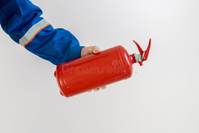 A Fireman Man Holding a Fire Extinguisher, Safe Work and Precautions ...