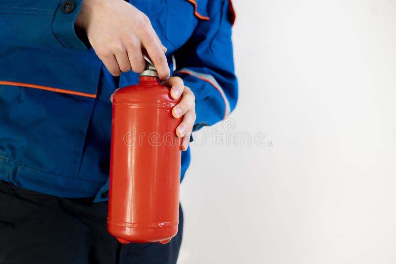 A Fireman Man Holding a Fire Extinguisher, Safe Work and Precautions ...