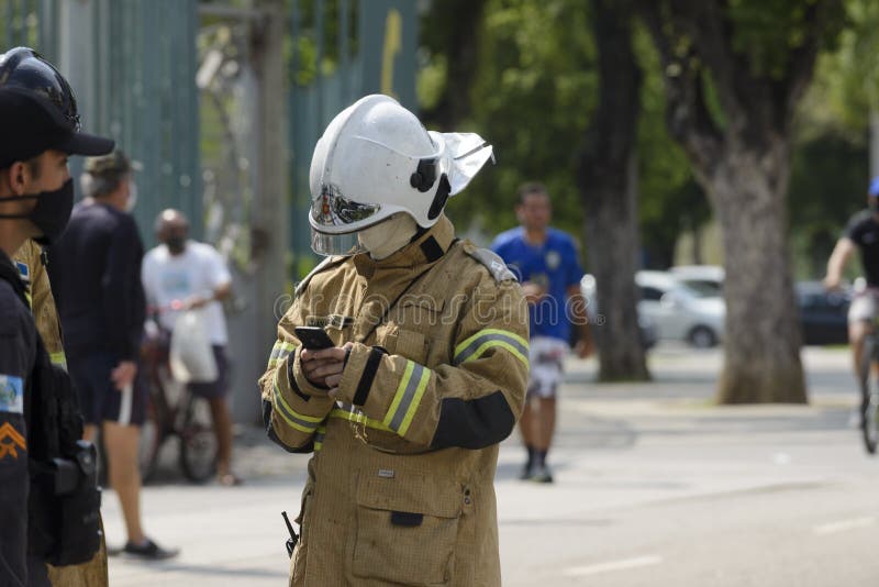 Fireman Man Makes Notes on His Cell Phone Editorial Image - Image of ...