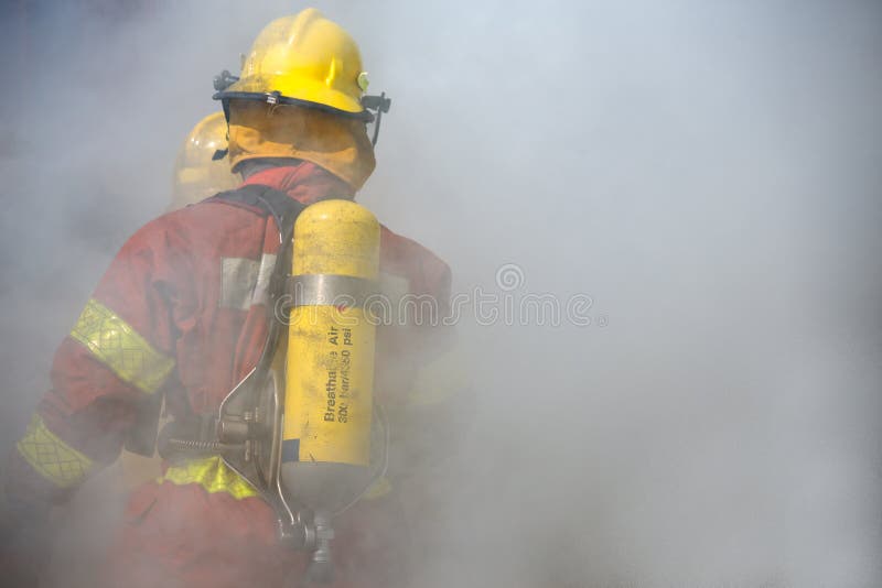 Fireman in Operation Surround with Smoke Stock Image - Image of tool ...