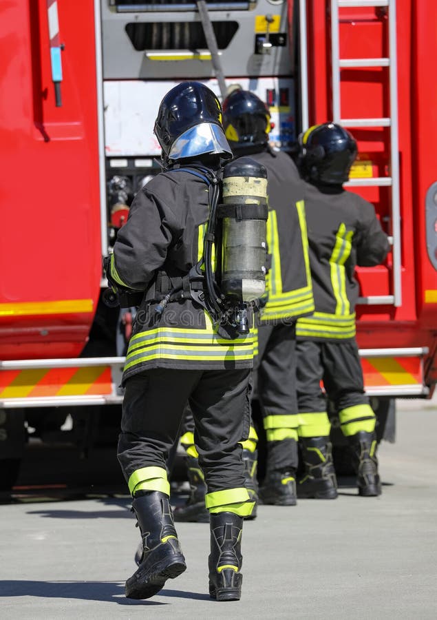 Fireman with Oxygen Tank and Fire Truck in the Background Stock Photo ...