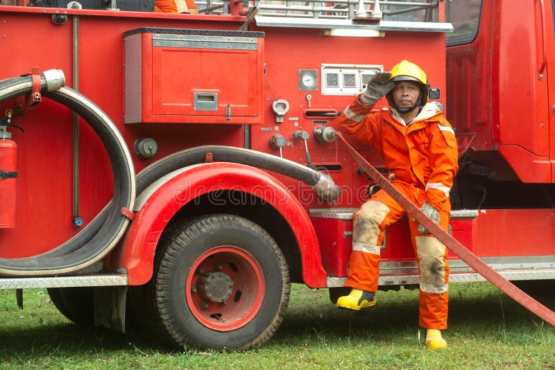 The Fireman is Preparing To Put Out the Fire at the Fire Engine ...