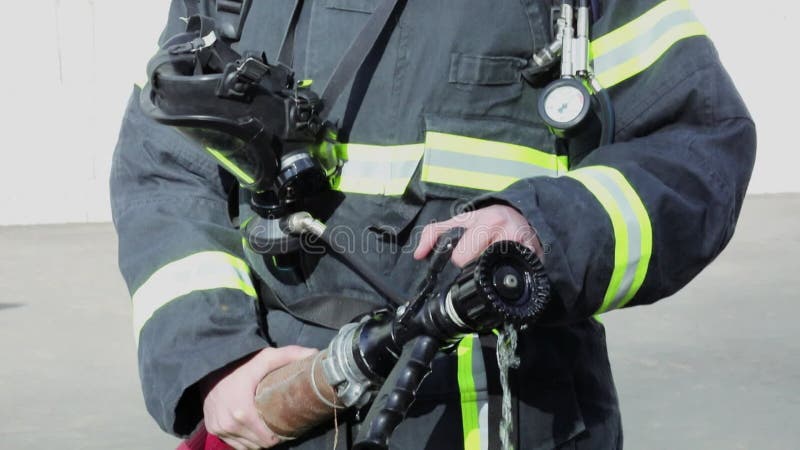 Fireman in Protective Suit and Helmet Holds Hose Stock Footage - Video ...