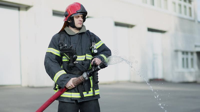 Fireman in Protective Uniform Adjusts Water Stream Stock Footage ...