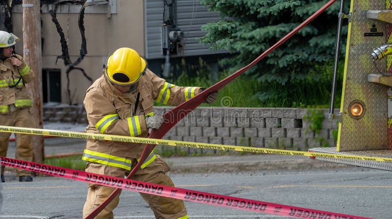 Firefighter Pulling a Fire Hose Stock Photo - Image of catégorie, green ...