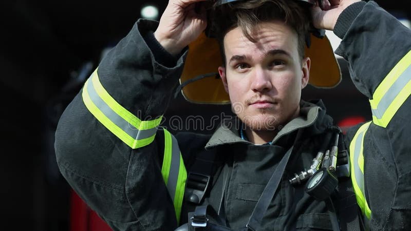 Fireman Puts on Red Fire Helmet with Face Stock Video - Video of close ...