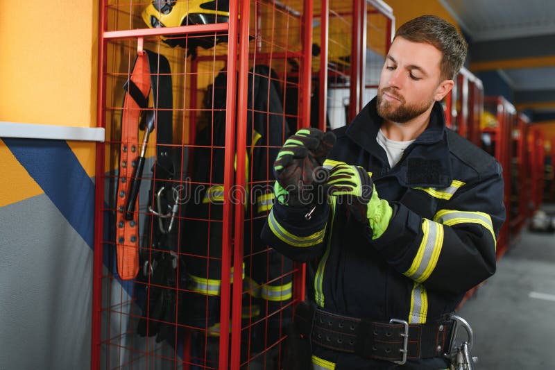 Fireman Putting on Protective Uniform and Preparing for Action while ...