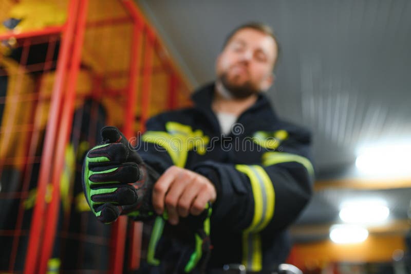 Fireman Putting on Protective Uniform and Preparing for Action while ...