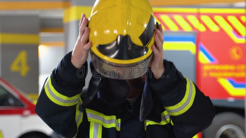 Fireman Removes the Protective Helmet at the Fire Station Stock Footage ...