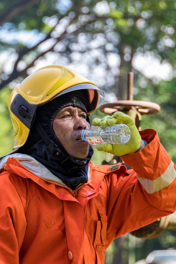 Fireman Rest and Drinking Water in Work Site. Stock Image - Image of ...