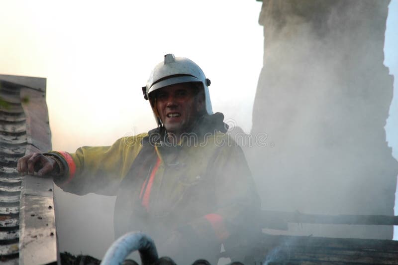 Portrait of Fireman in a Special Form on the Roof of a Burning House ...