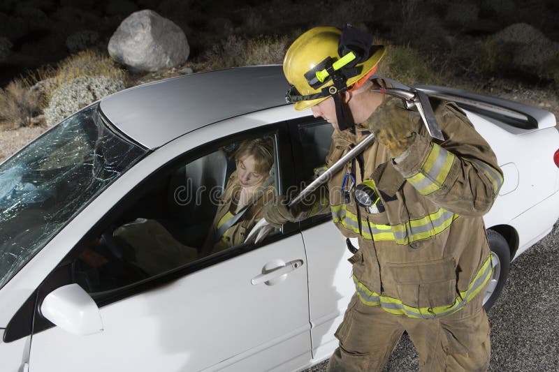 Fireman Trying To Open Car S Door Stock Image - Image of middle ...