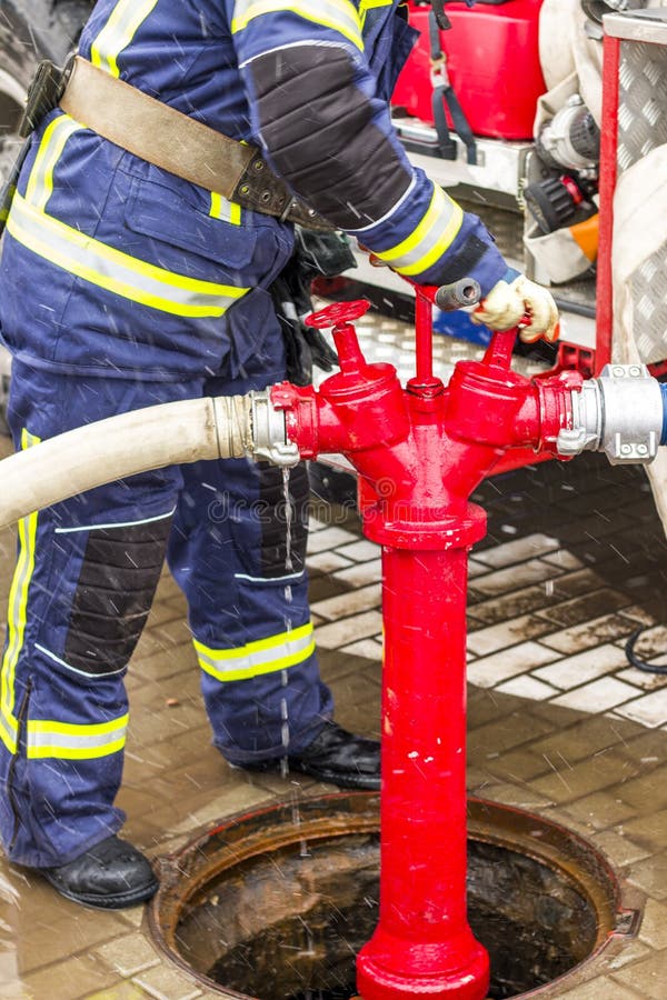 Fireman Turns Taps on the Hydrant Stock Photo - Image of protective ...